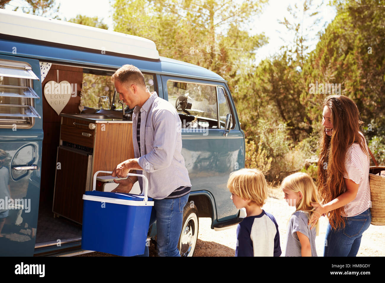 Family packing up their camper van for a road trip vacation Stock Photo ...