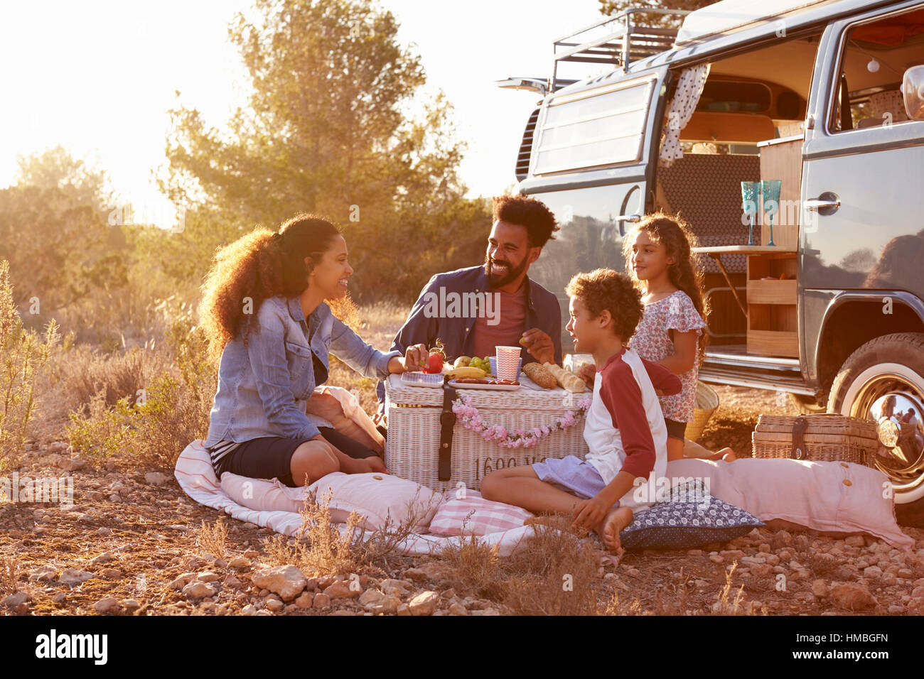 Family having a picnic beside their camper van, full length Stock Photo ...
