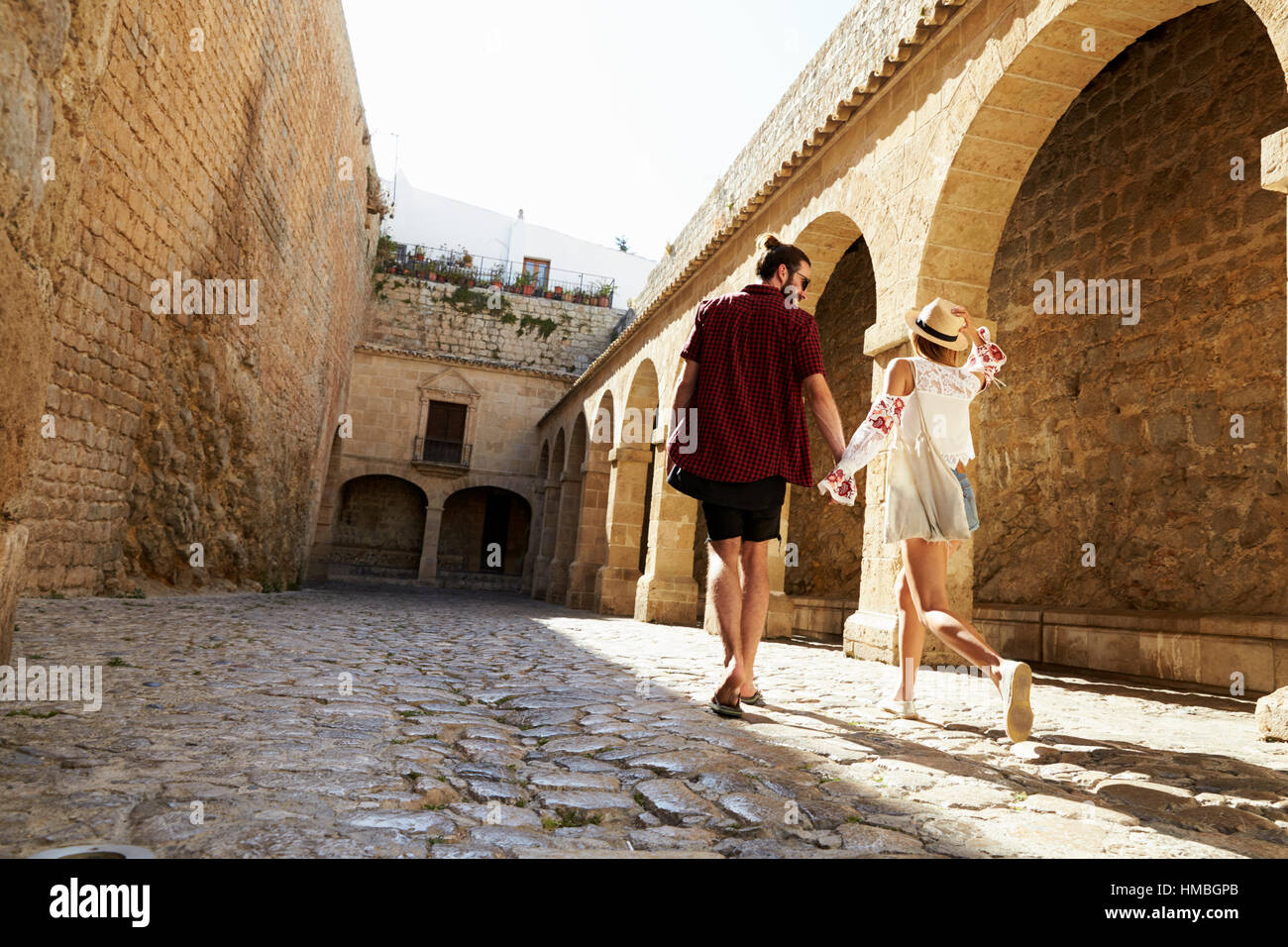 Couple sightseeing old buildings, back view, Ibiza, Spain Stock Photo ...