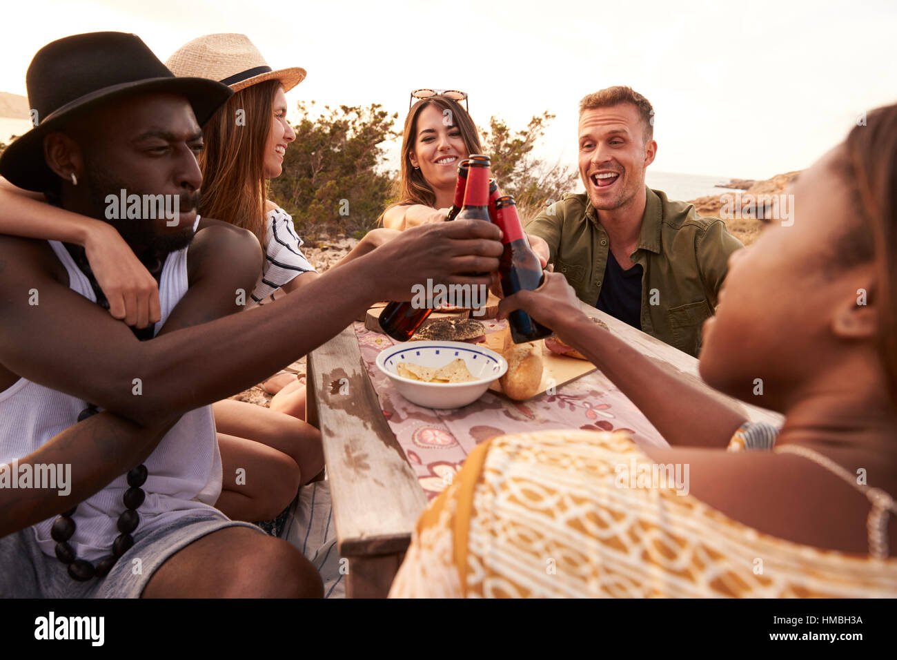 Group Of Friends Making A Toast On Cliff Top Picnic Stock Photo - Alamy