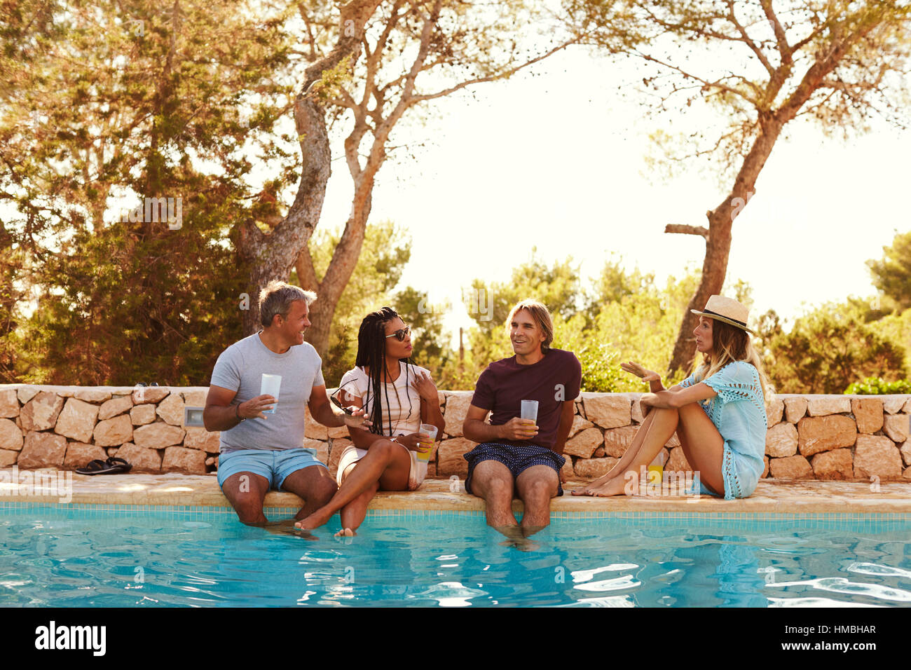 Sitting legs crossed by a swimming pool hi-res stock photography and ...