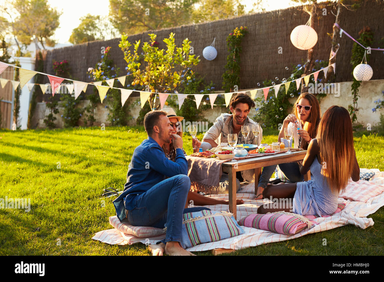 Group Of Friends Enjoying Outdoor Picnic In Garden Stock Photo - Alamy