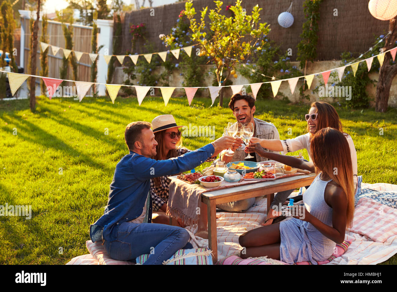 Group Of Friends Enjoying Outdoor Picnic In Garden Stock Photo - Alamy
