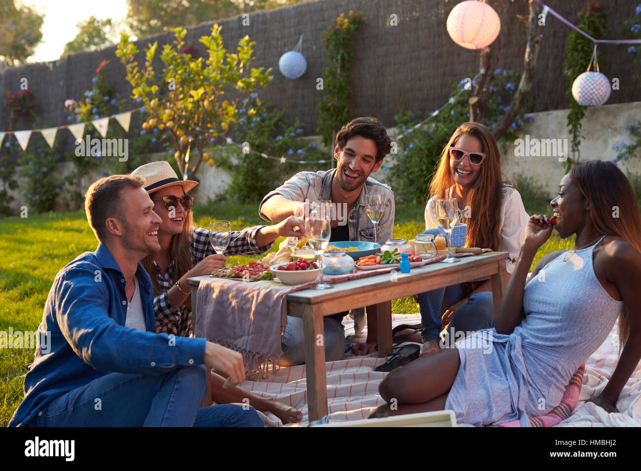 Group Of Friends Enjoying Outdoor Picnic In Garden Stock Photo - Alamy