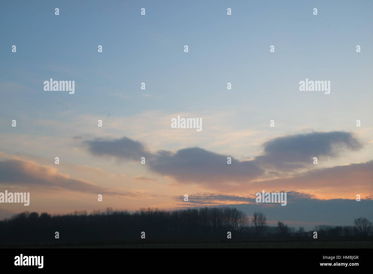 sunset with vaportrails Stock Photo - Alamy