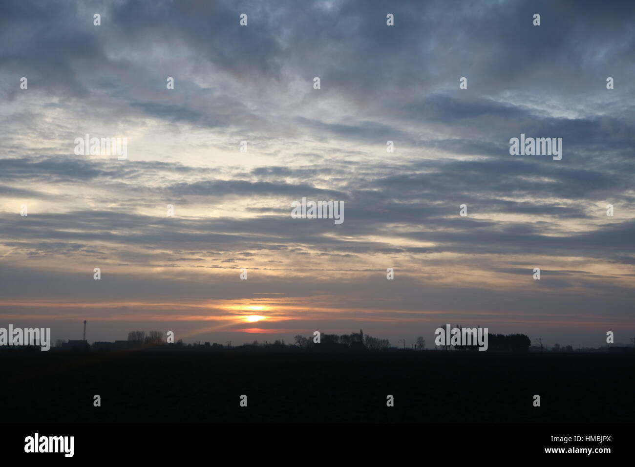 Sunrise sunset distance over the horizon Stock Photo - Alamy