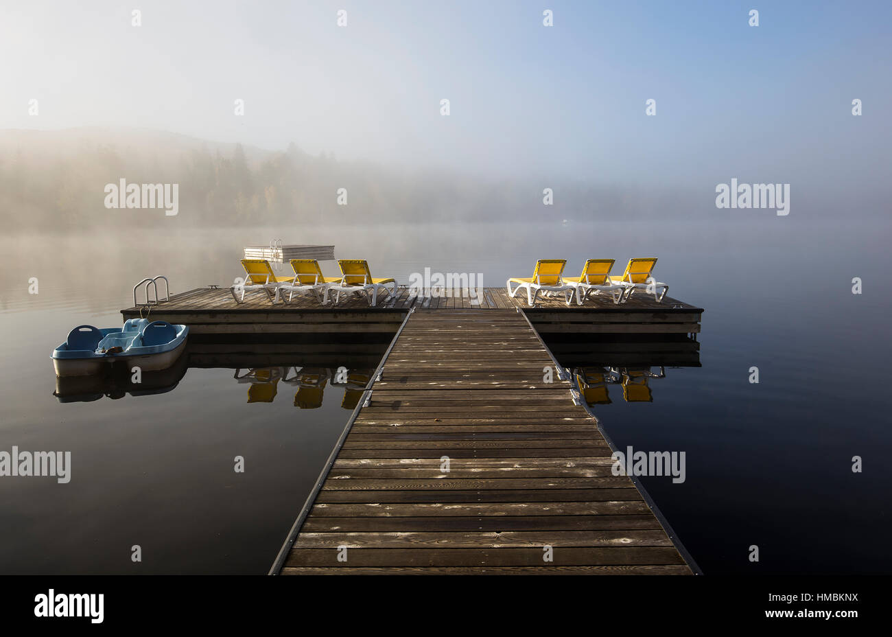 view of a boat dock the Lac-Superieur, misty morning with fog, in ...