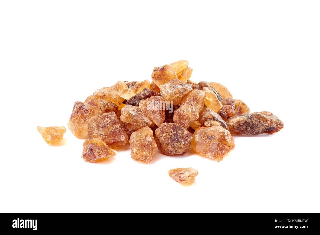 Heap of amber sugar on white Stock Photo - Alamy