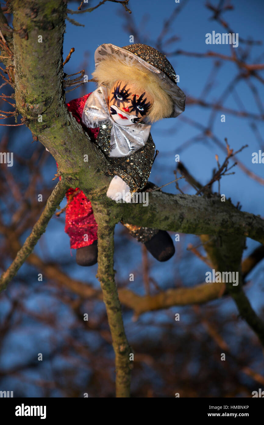 closeup of a scary evil clown in the woods, emerging from behind of a ...
