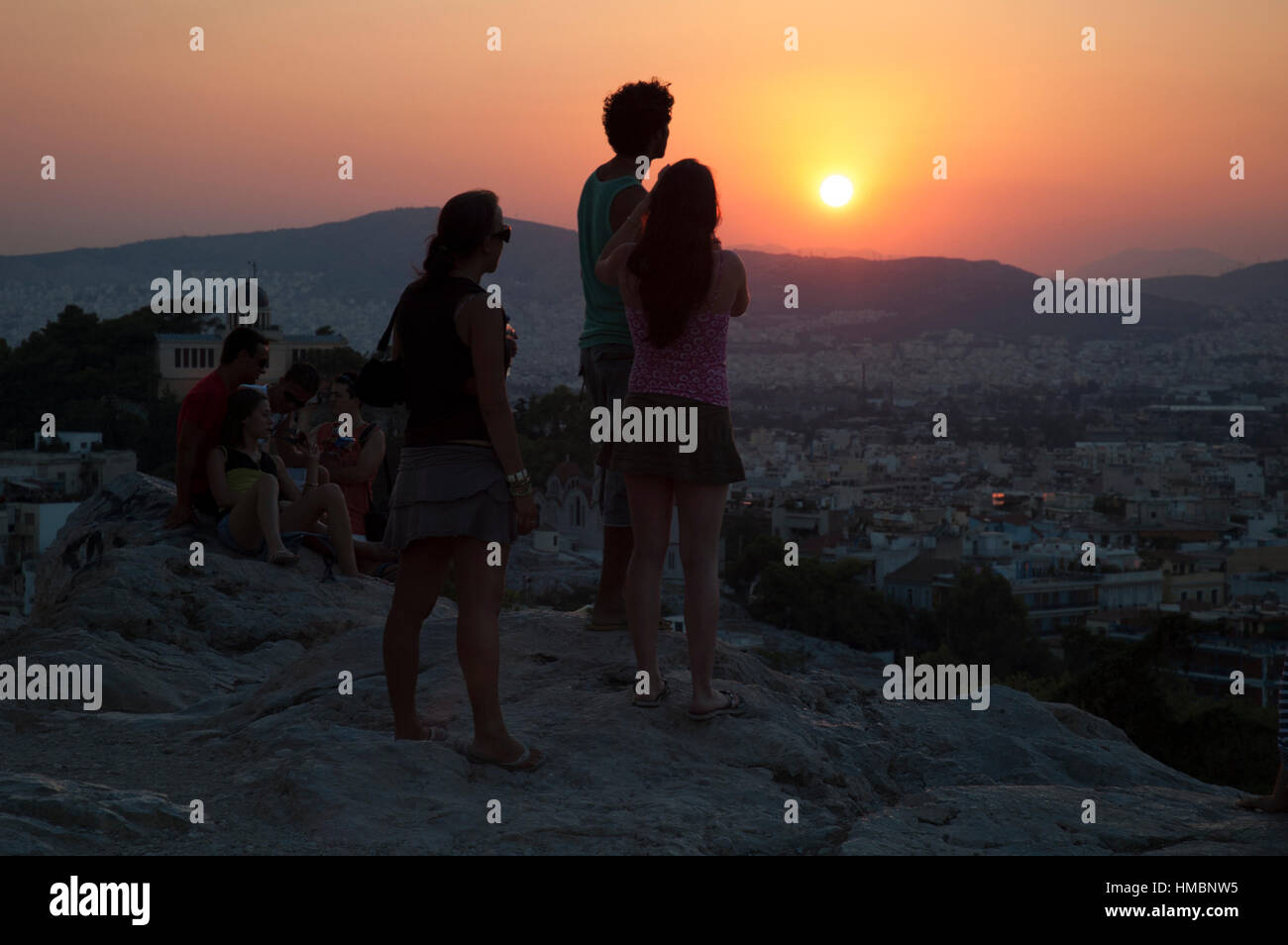 Athens sunset is been seen by tourists from Areopagus hill. Athens ...