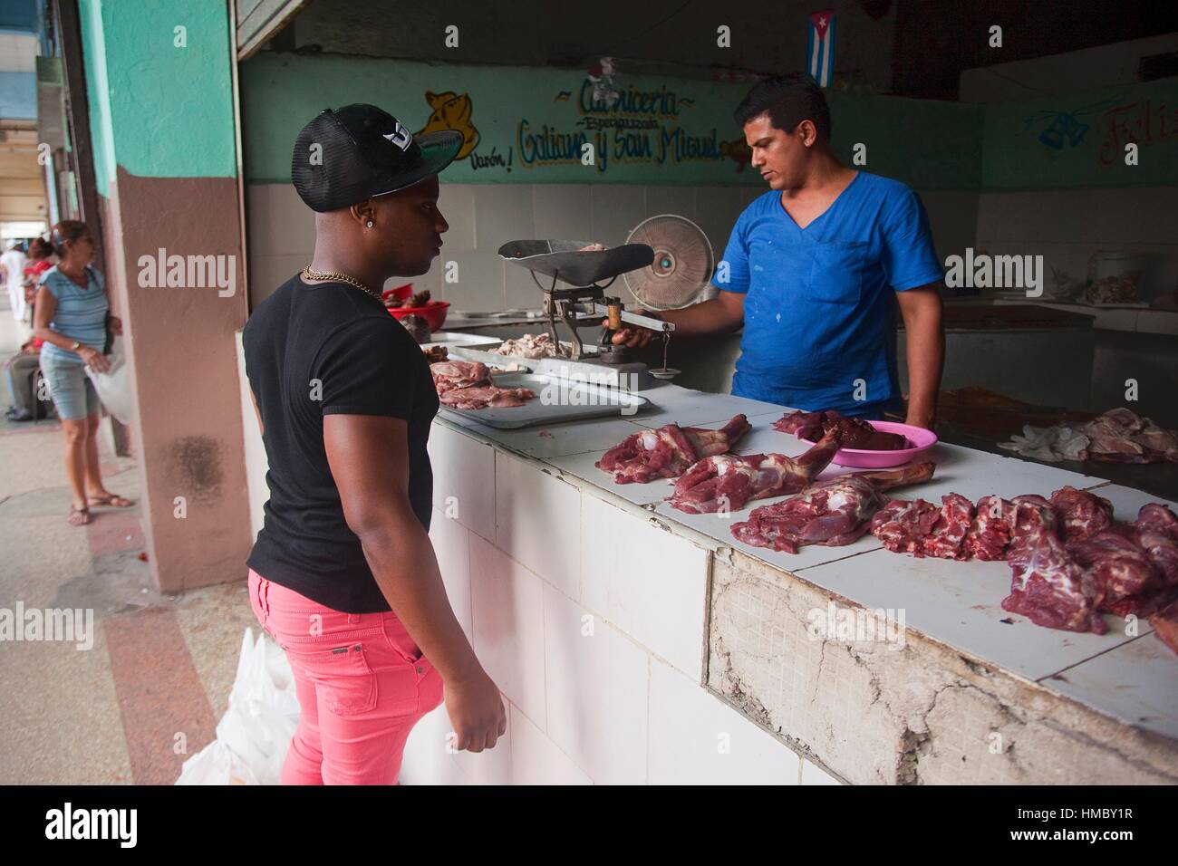 Young man buying meat from a shop at Center Havana, La Habana, Cuba ...