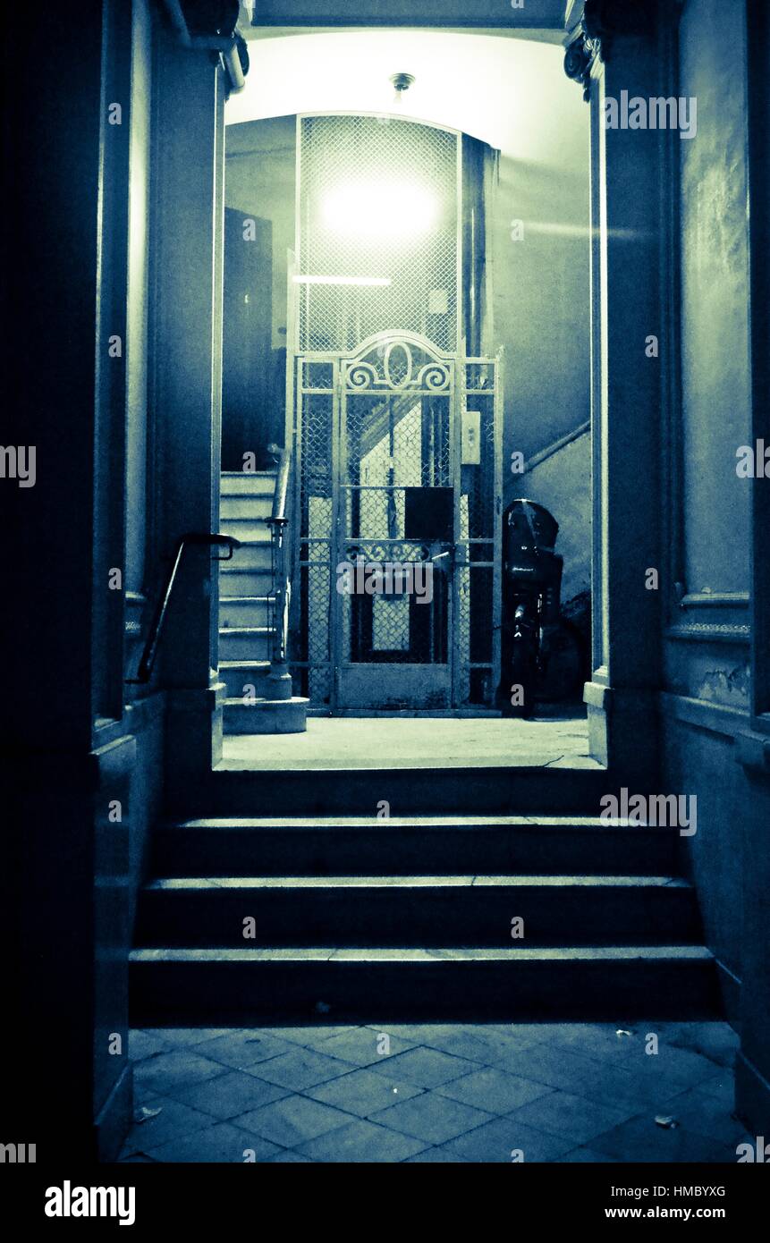 Stairs and elevator in entrance of a house at night Stock Photo - Alamy