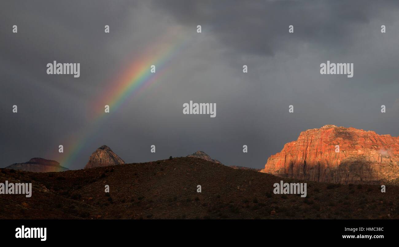A passing thunderstorm produces a rainbow at Zion National Park, Utah ...