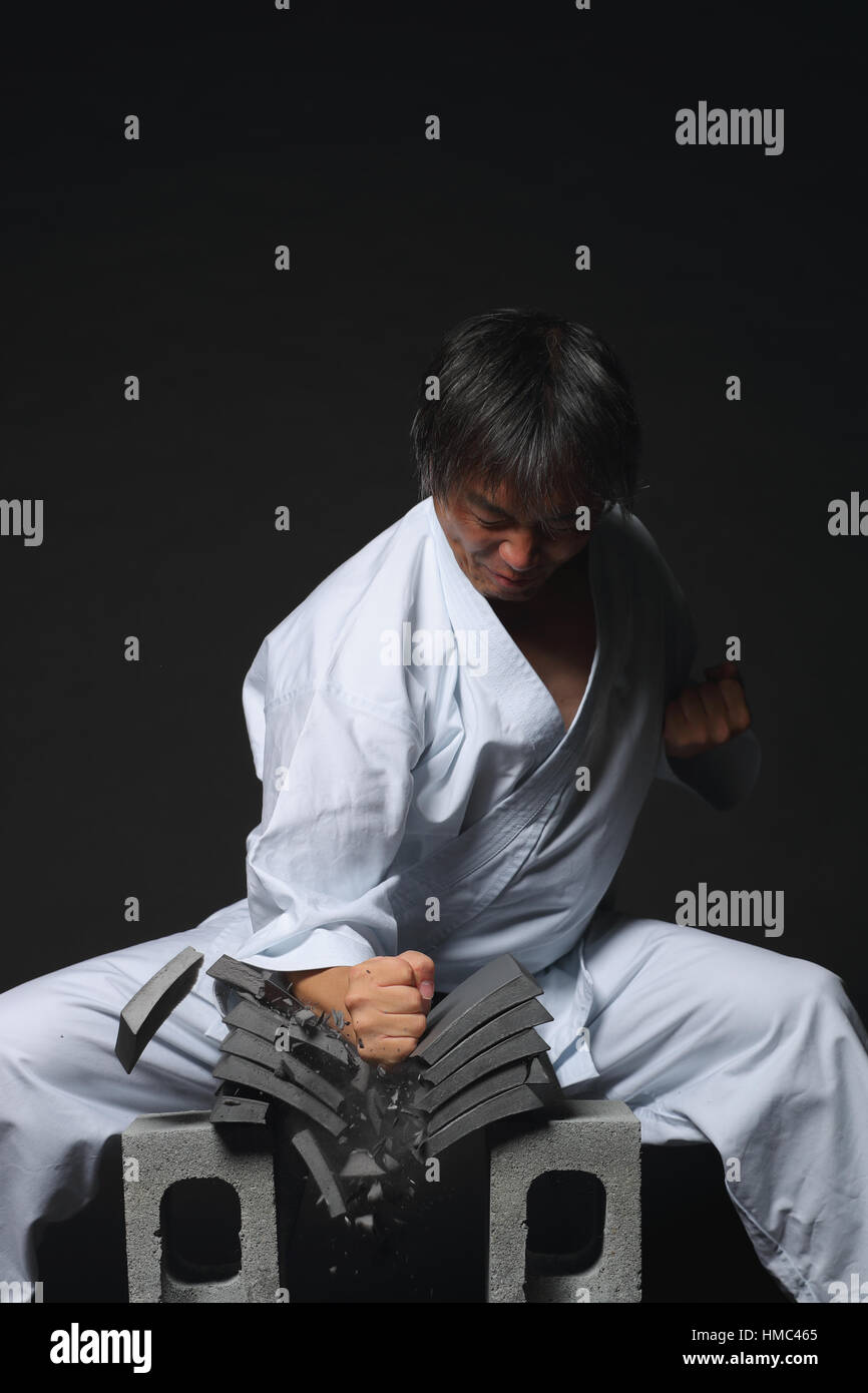 Japanese karate master breaking tiles Stock Photo - Alamy