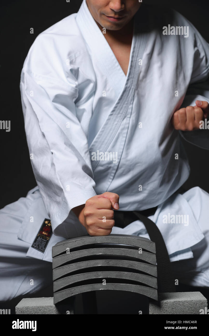Japanese karate master breaking tiles Stock Photo - Alamy