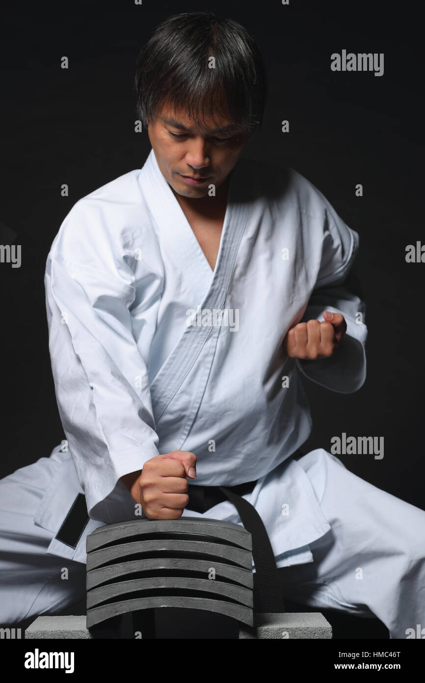 Japanese karate master breaking tiles Stock Photo - Alamy