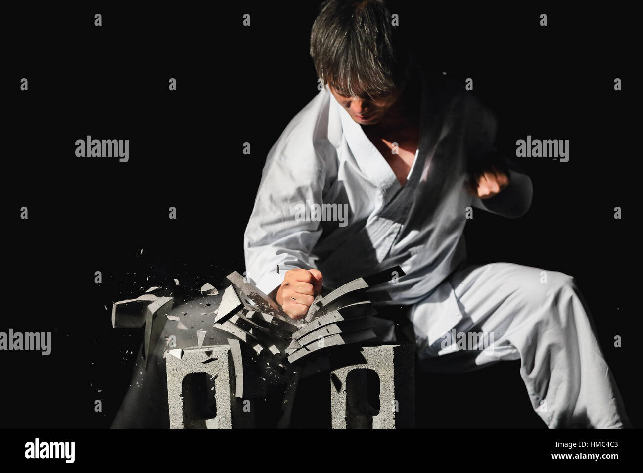Japanese karate master breaking tiles Stock Photo - Alamy