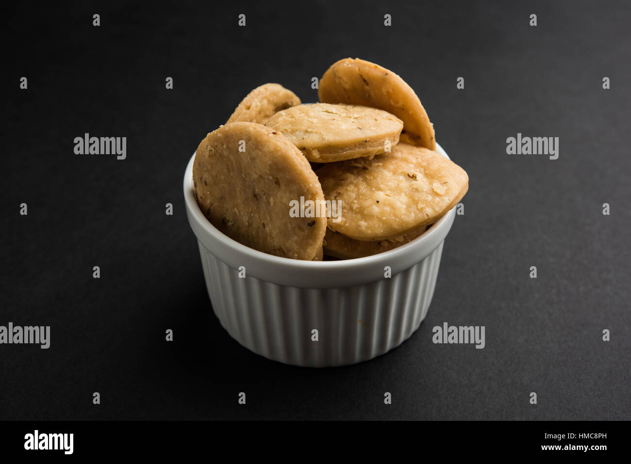 spicy fried mathri or mathari which is an indian snack served with a ...