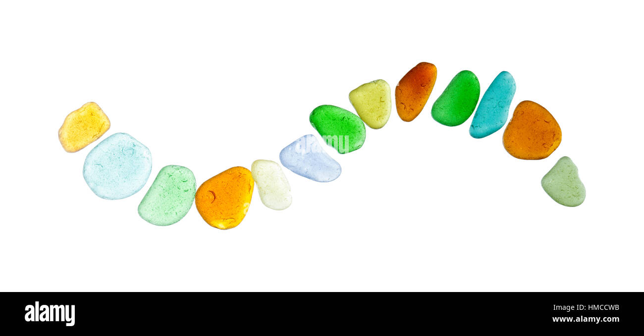 backlit sea glass peices isolated on white background, shape of a wave ...