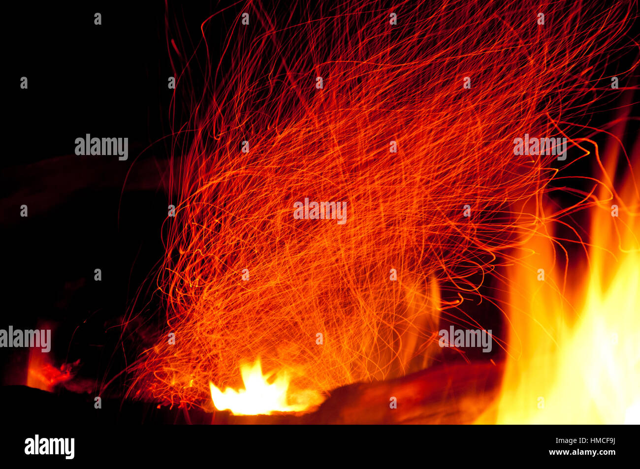 Embers in a fire glow and swirl upward Stock Photo - Alamy
