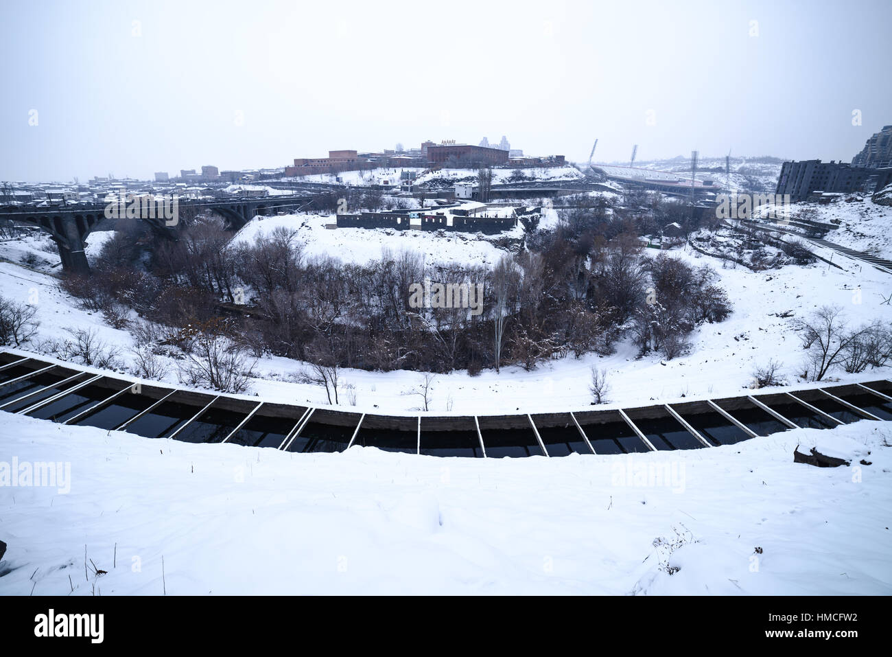 Razdan river in Yerevan city center with Victory bridge and Ararat wine ...