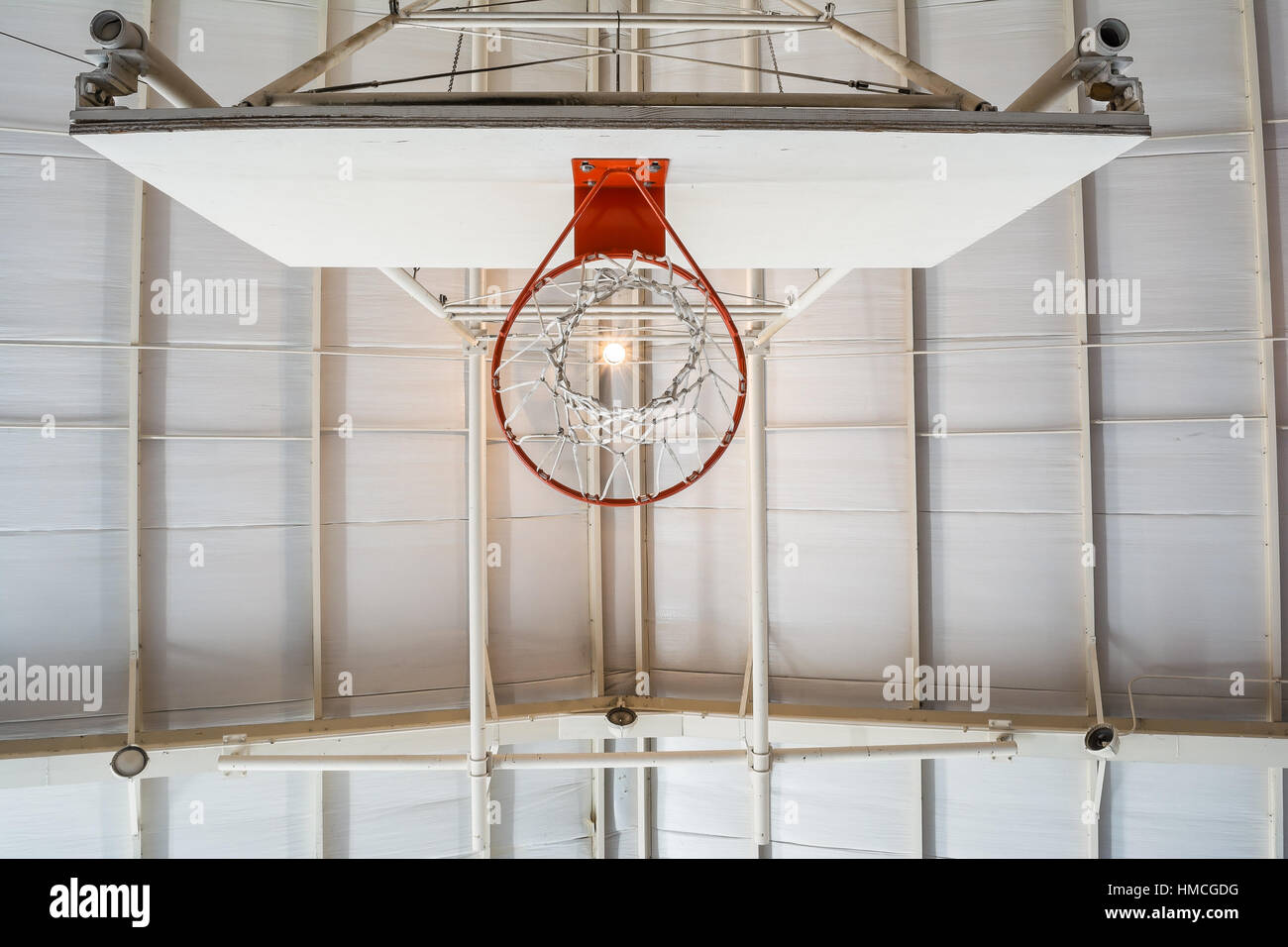 Looking up perspective at a basketball backboard and hoop in the school ...