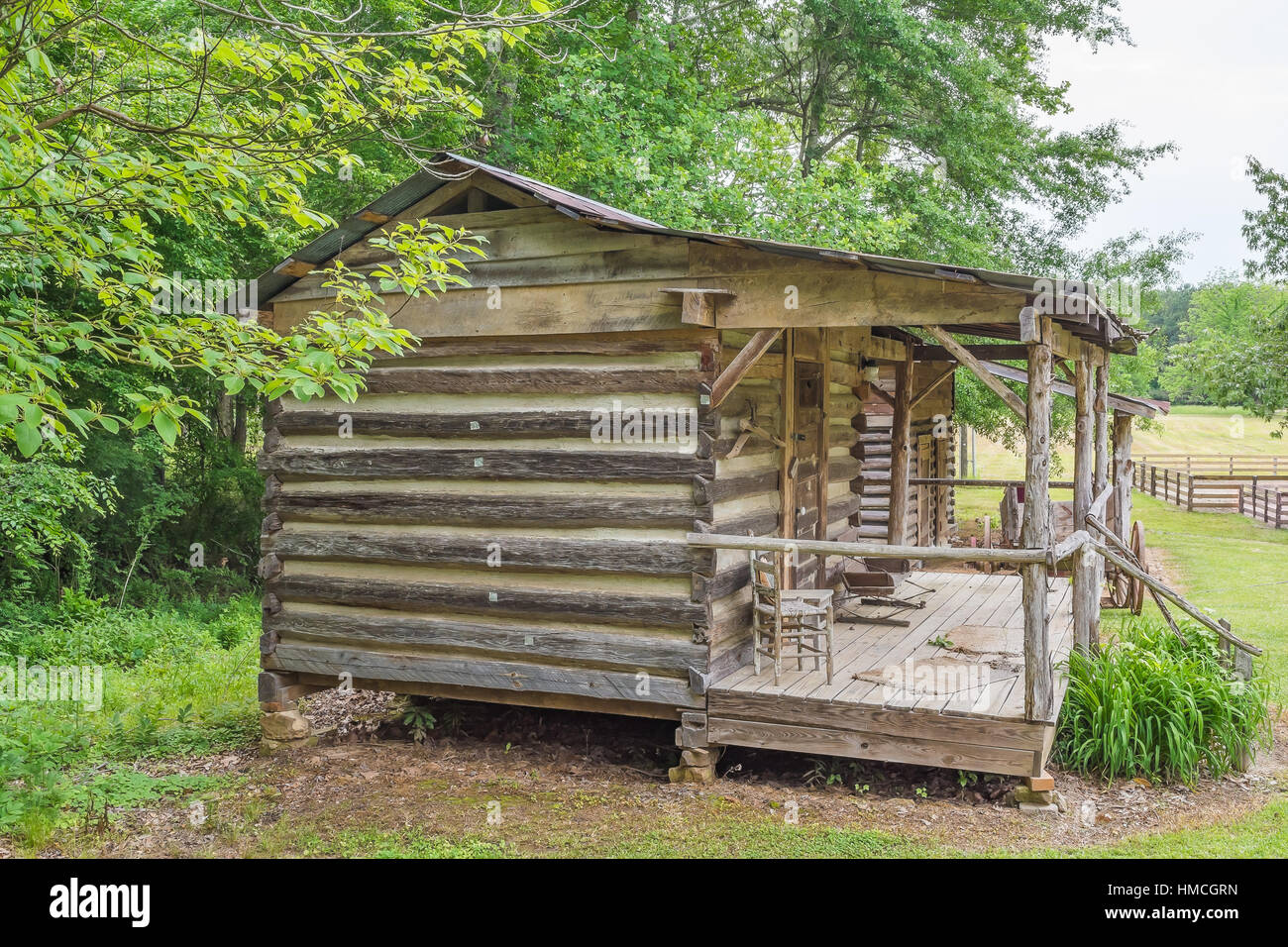 A primitive log cabin near the edge of the woods Stock Photo - Alamy