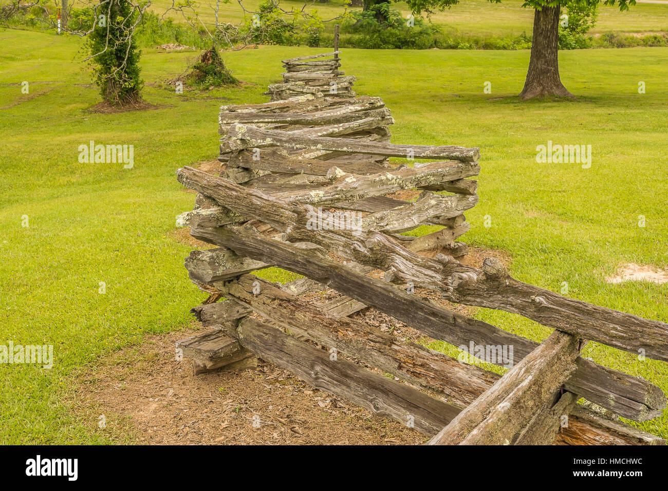 A retro, split log fence running in a zig zag direction Stock Photo - Alamy