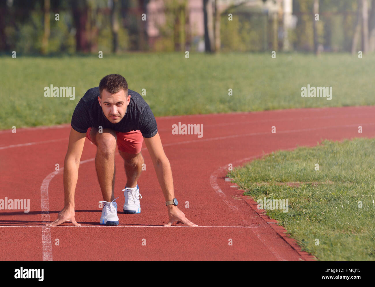 Athletic man on track starting to run. Healthy fitness concept with ...