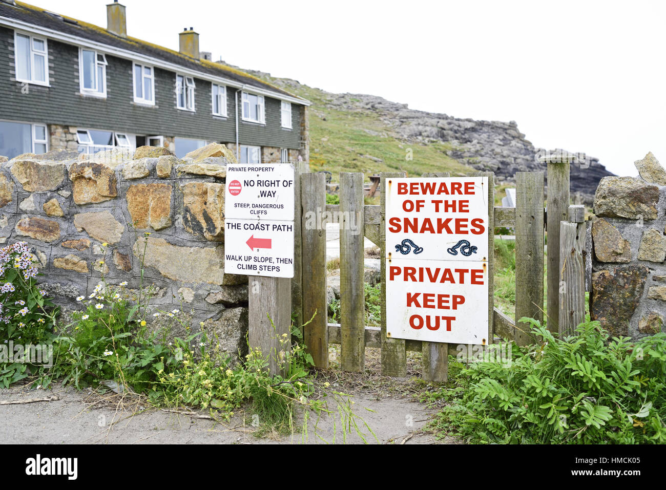 Sign by a row of houses in Sennen Cove, Cornwall, trying to frighten ...