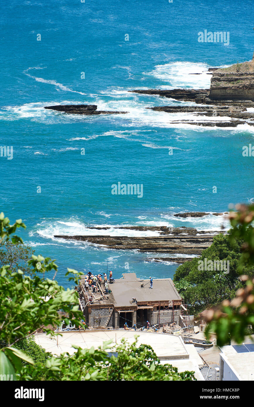 building house in ocean side with blue water Stock Photo - Alamy