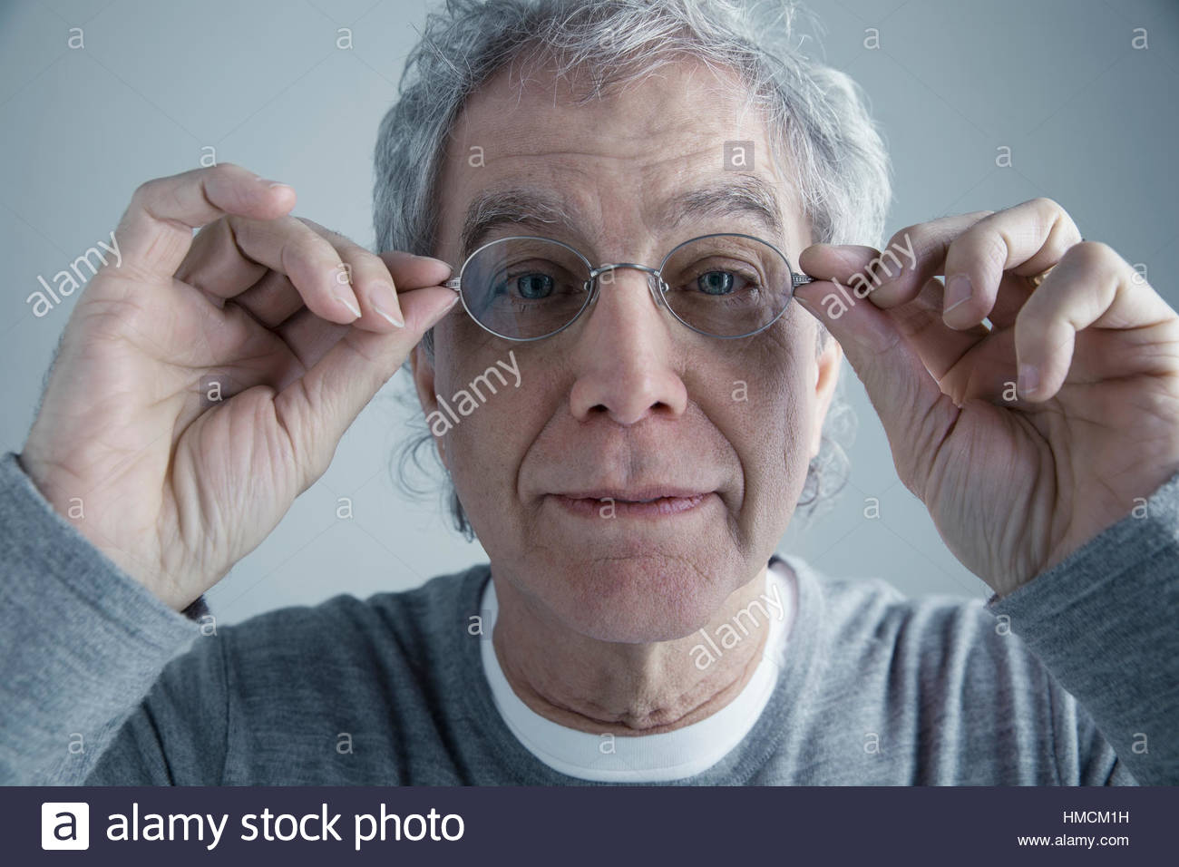 Portrait Caucasian Senior Man With Gray Hair Adjusting Eyeglasses Stock