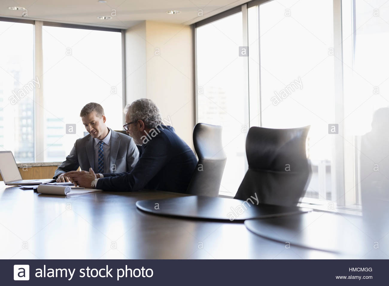 Male lawyers talking in conference room meeting Stock Photo - Alamy