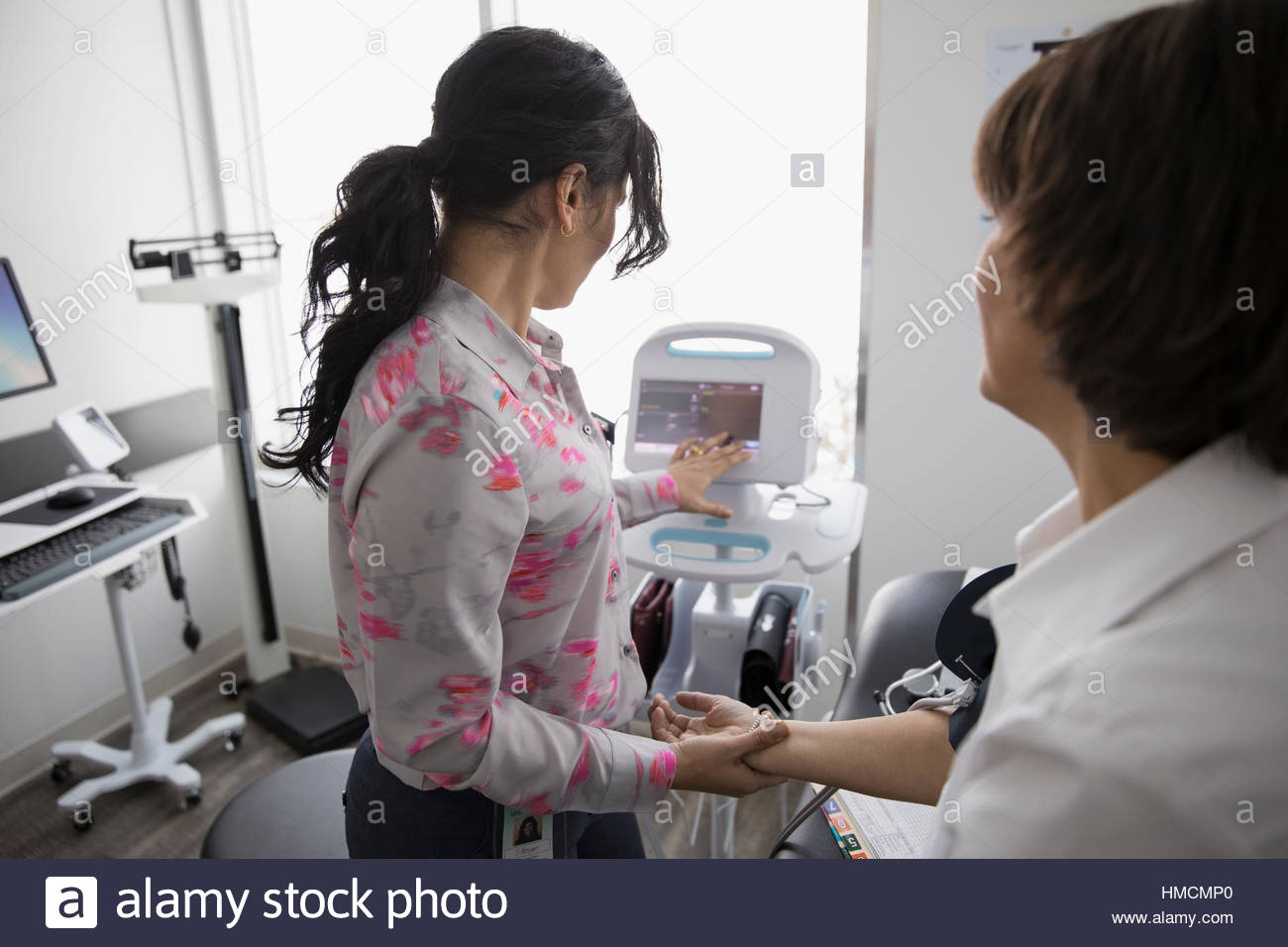 Female doctor checking pulse hi-res stock photography and images - Alamy