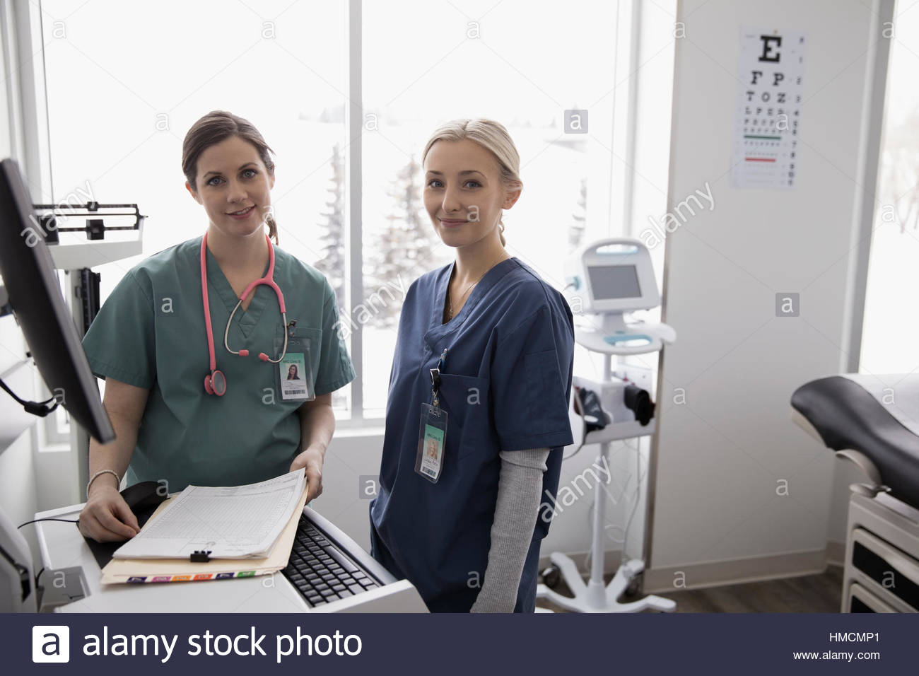 Smiling nurse looking medical chart hi-res stock photography and images ...