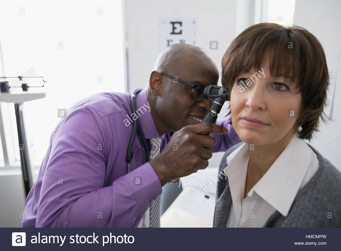 Doctor examining ear woman hi-res stock photography and images - Alamy