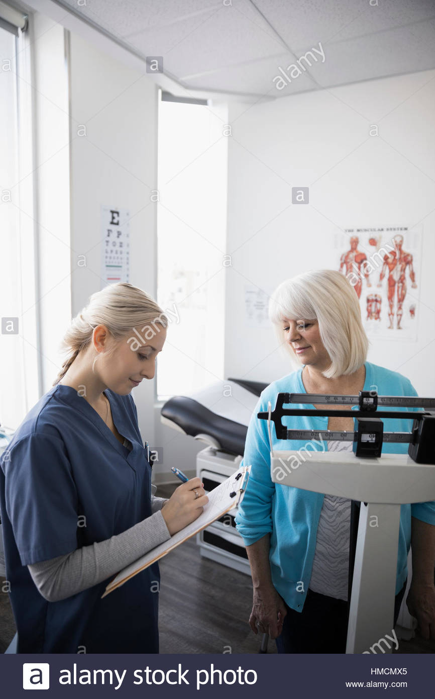 Woman holding weight scale hi-res stock photography and images - Alamy