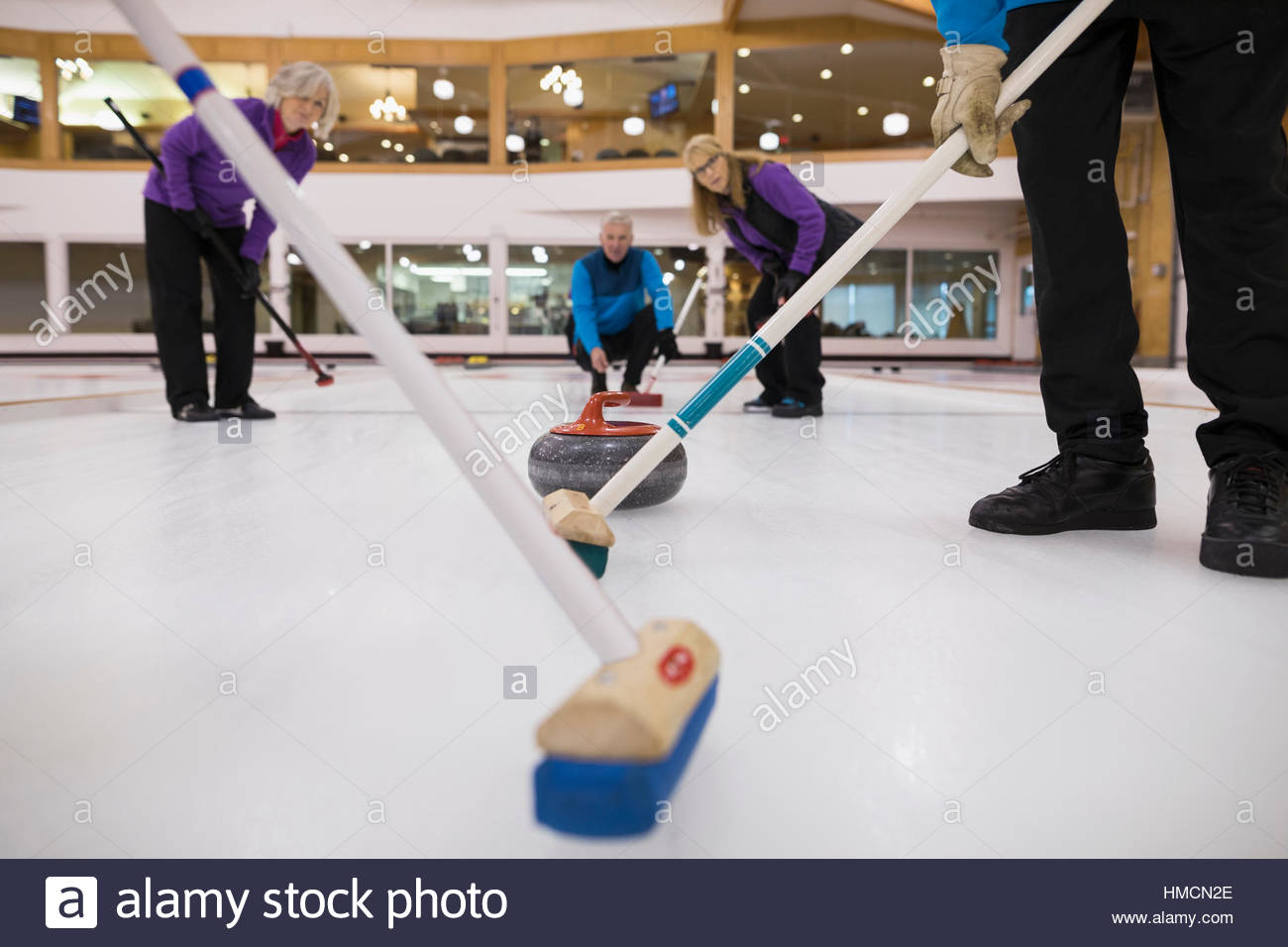 Senior adults curling Stock Photo - Alamy