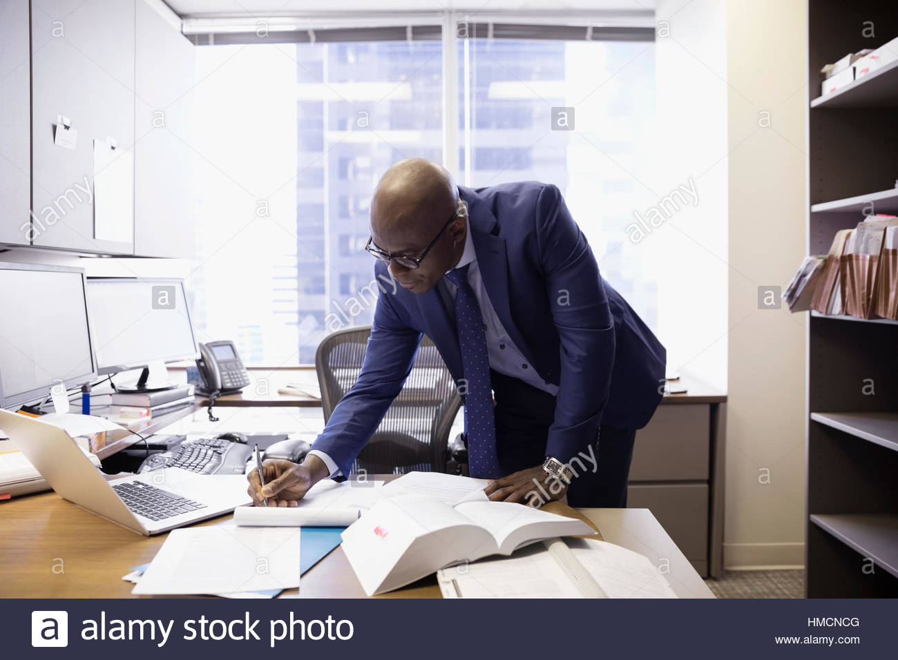 Male lawyer researching in office Stock Photo - Alamy