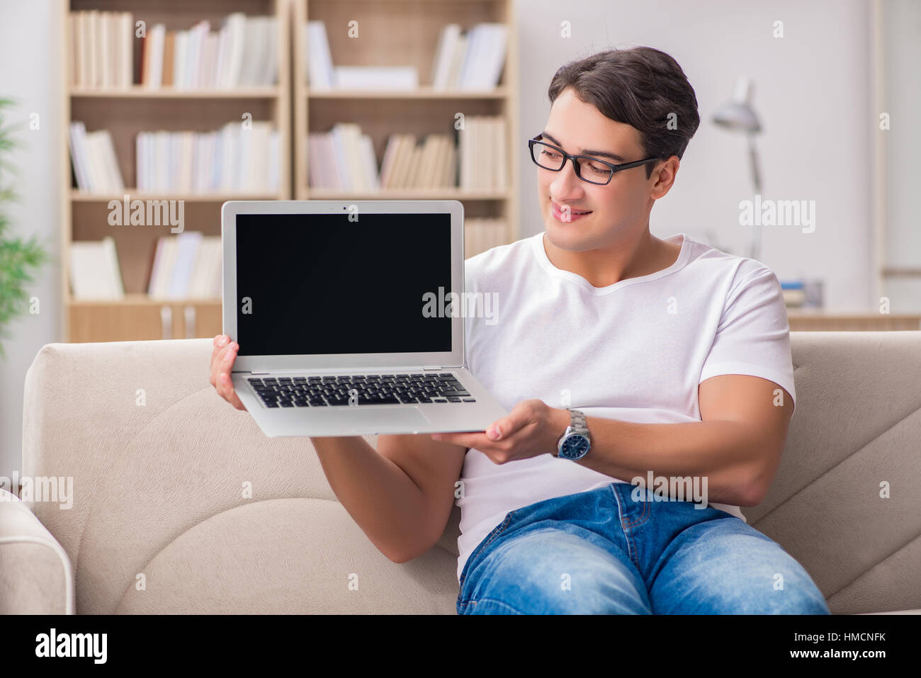 Man working sitting in couch sofa Stock Photo - Alamy