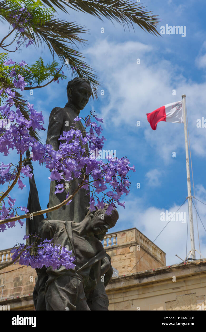 Maltese flag waving on top of an official government building in ...