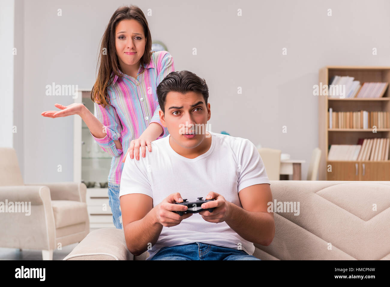Young family suffering from computer games addiction Stock Photo - Alamy