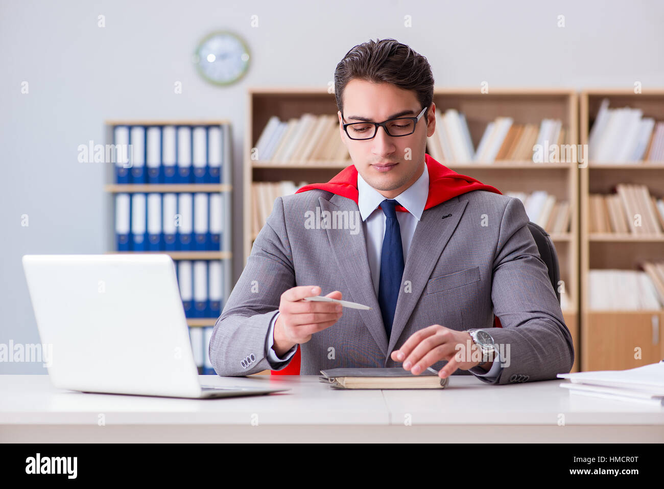Superhero businessman working in the office Stock Photo - Alamy