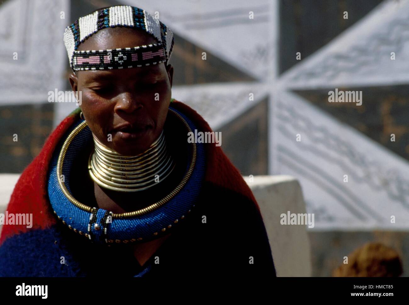 Ndebele woman wearing a traditional costume and idzilla, bronze or copper neck rings, South ...
