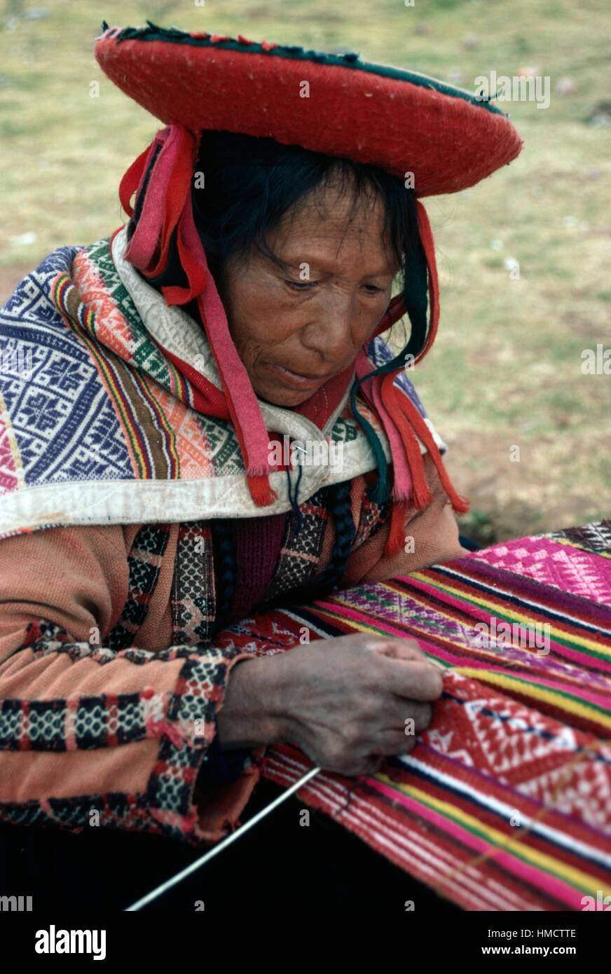 Woman wearing traditional clothing weaving on a loom, Cuzco, Peru Stock ...