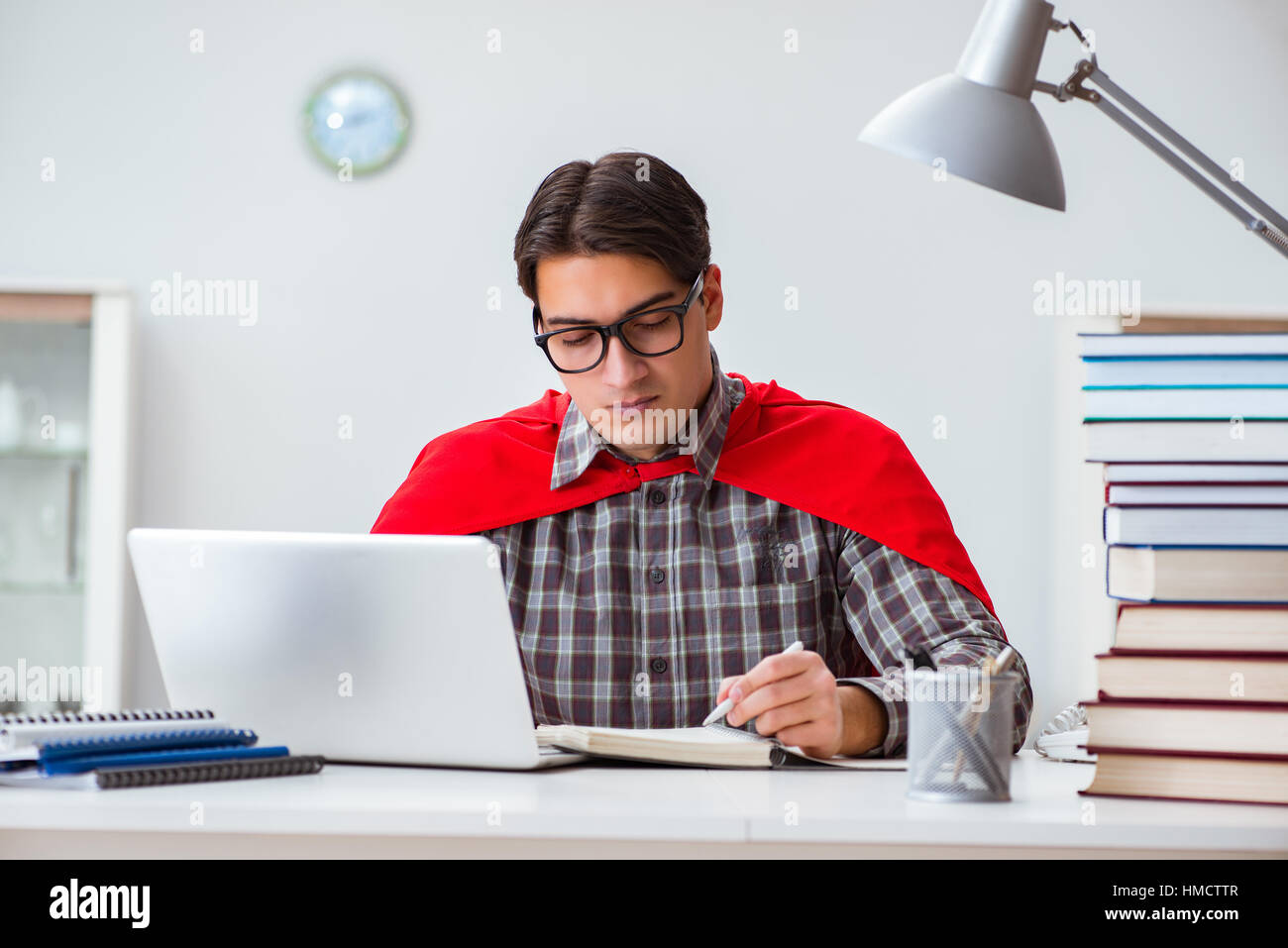 Super hero student with books studying for exams Stock Photo - Alamy