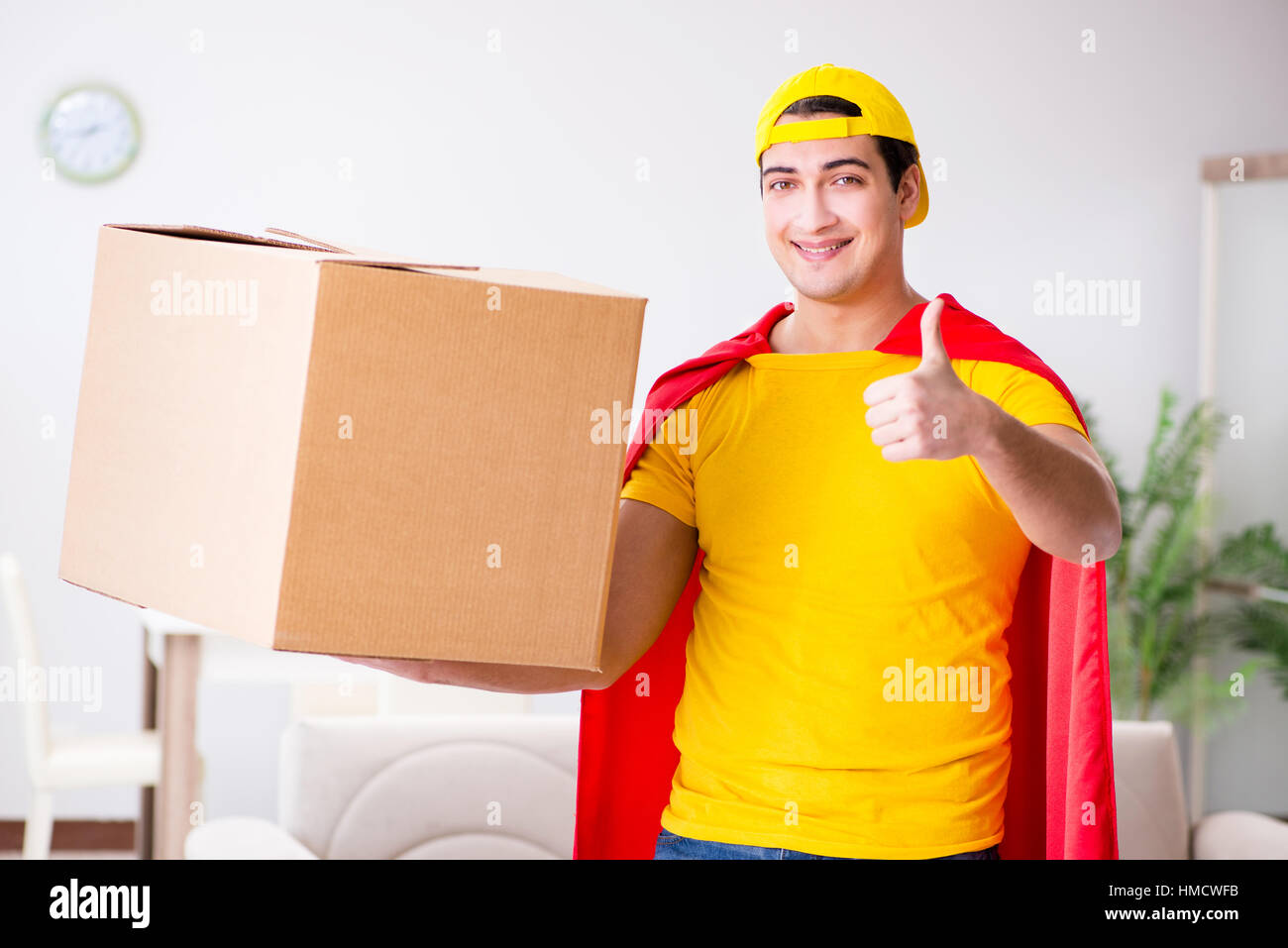 Superhero delivery guy with box Stock Photo - Alamy