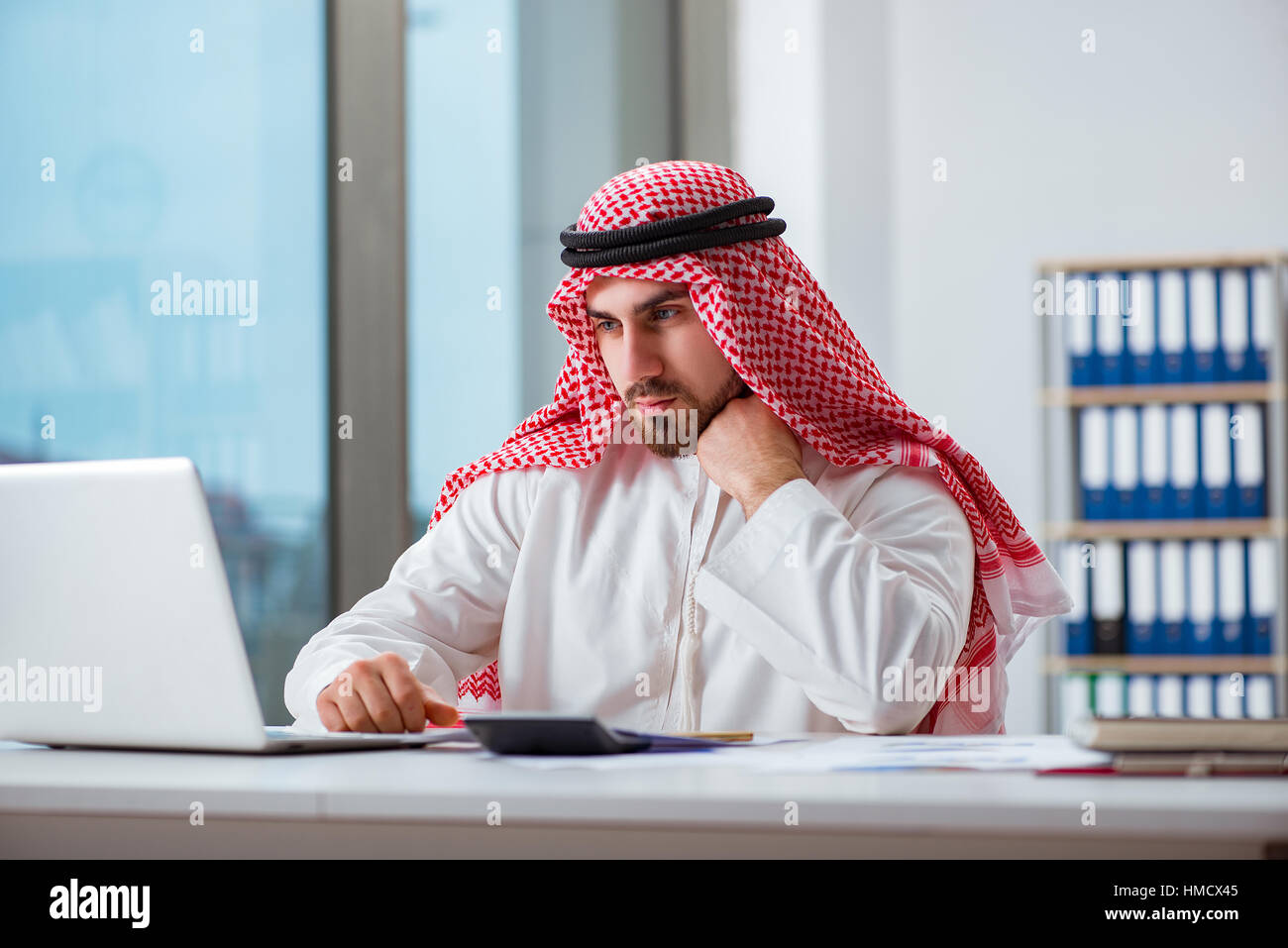 Arab businessman working on laptop computer Stock Photo - Alamy