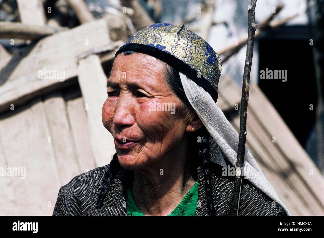 Uighur woman with stick and traditional headdress, Kashgar, China Stock ...