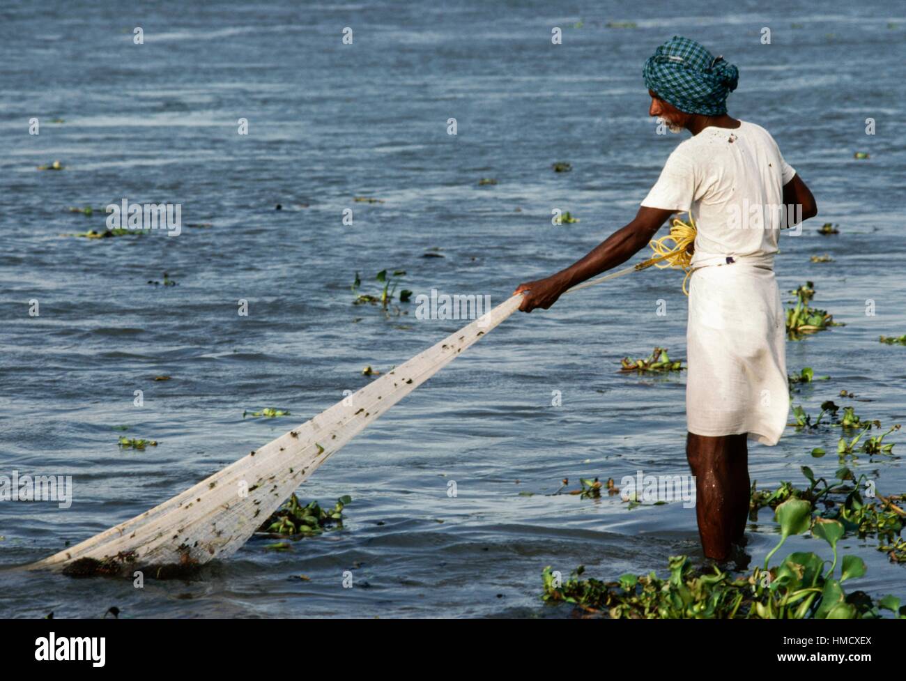Fisherman pulling a net along the Chinese fishing nets (Cheena vala ...